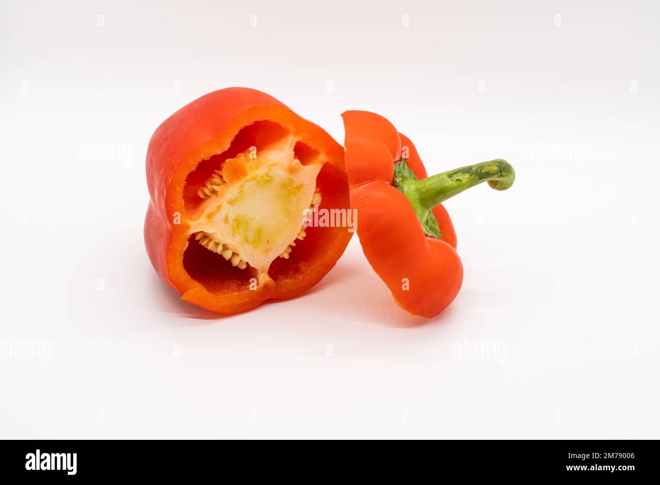 A Red Bell Pepper (Capsicum) with the top cut off isolated on a white ...