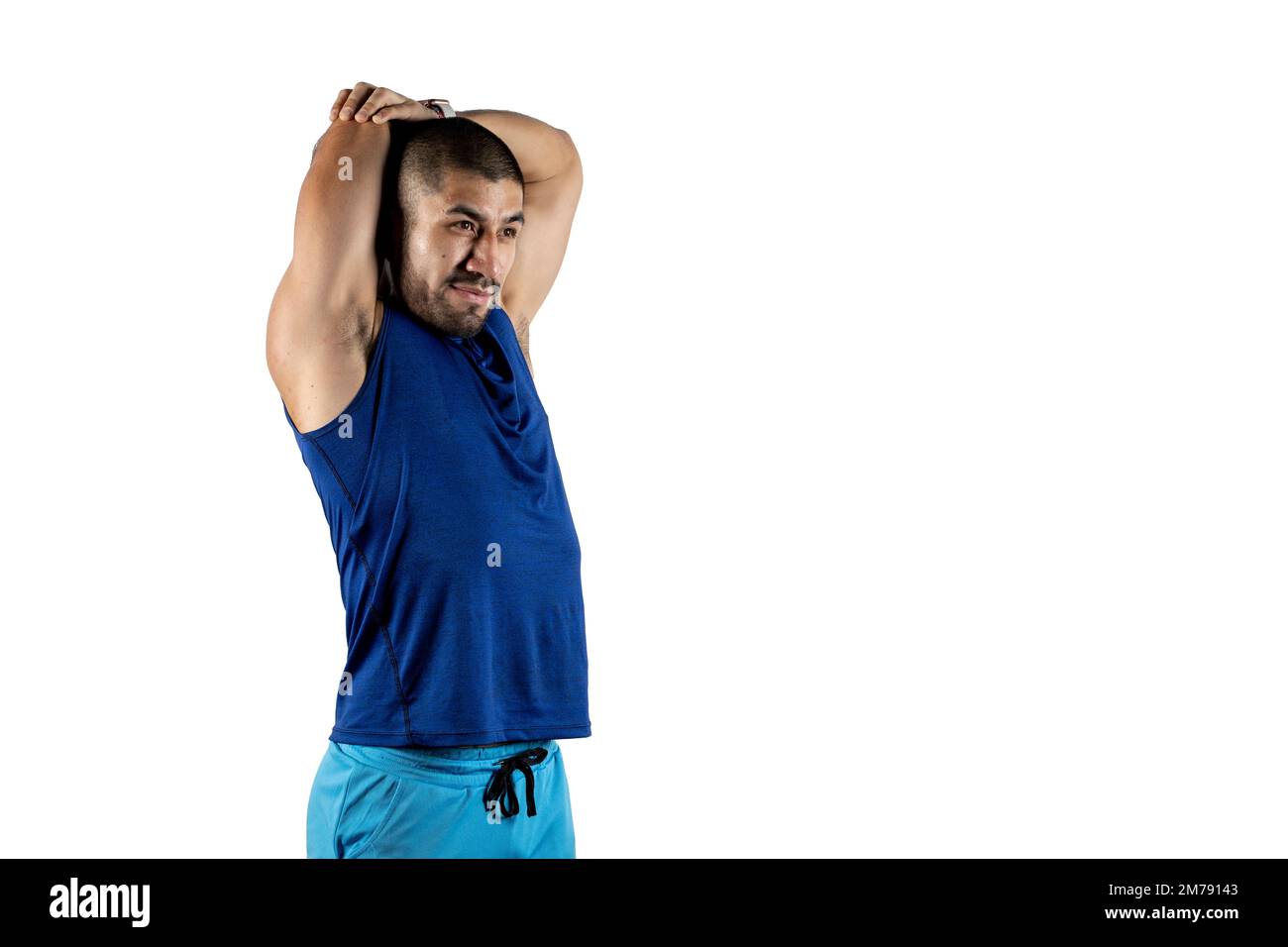 A Latino man does an arm stretch, with copy space and a white ...