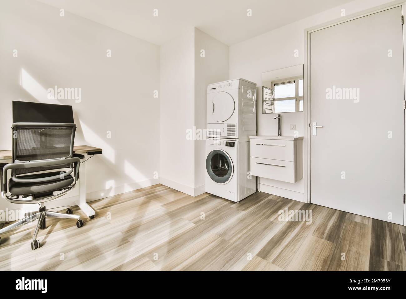 a laundry room with a washer, dryer and washing machine on the floor in ...