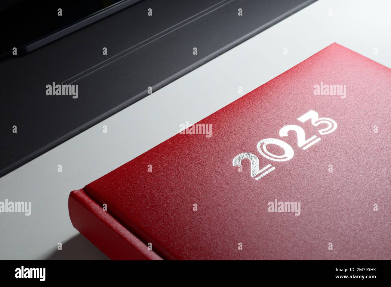 2023 red diary on a desk Stock Photo - Alamy