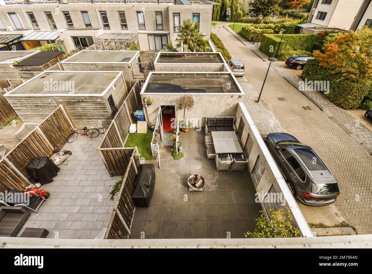 an aerial view of a house with cars parked in the driveway and two ...