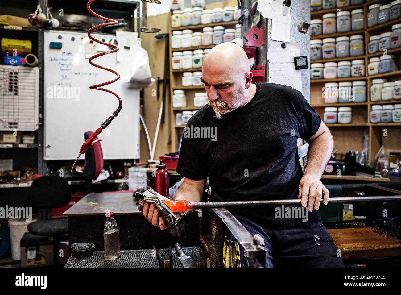 Glass blower working in workshop Stock Photo - Alamy