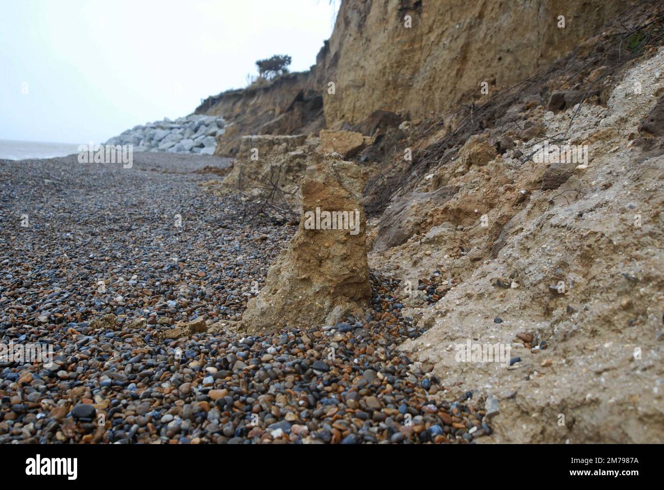 Column of debris, in line of slumped cliff material, with granite rock ...