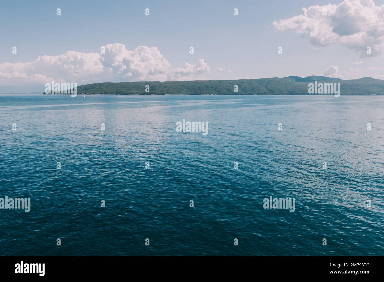 Summer coastline near an island on the deep blue ocean Stock Photo - Alamy
