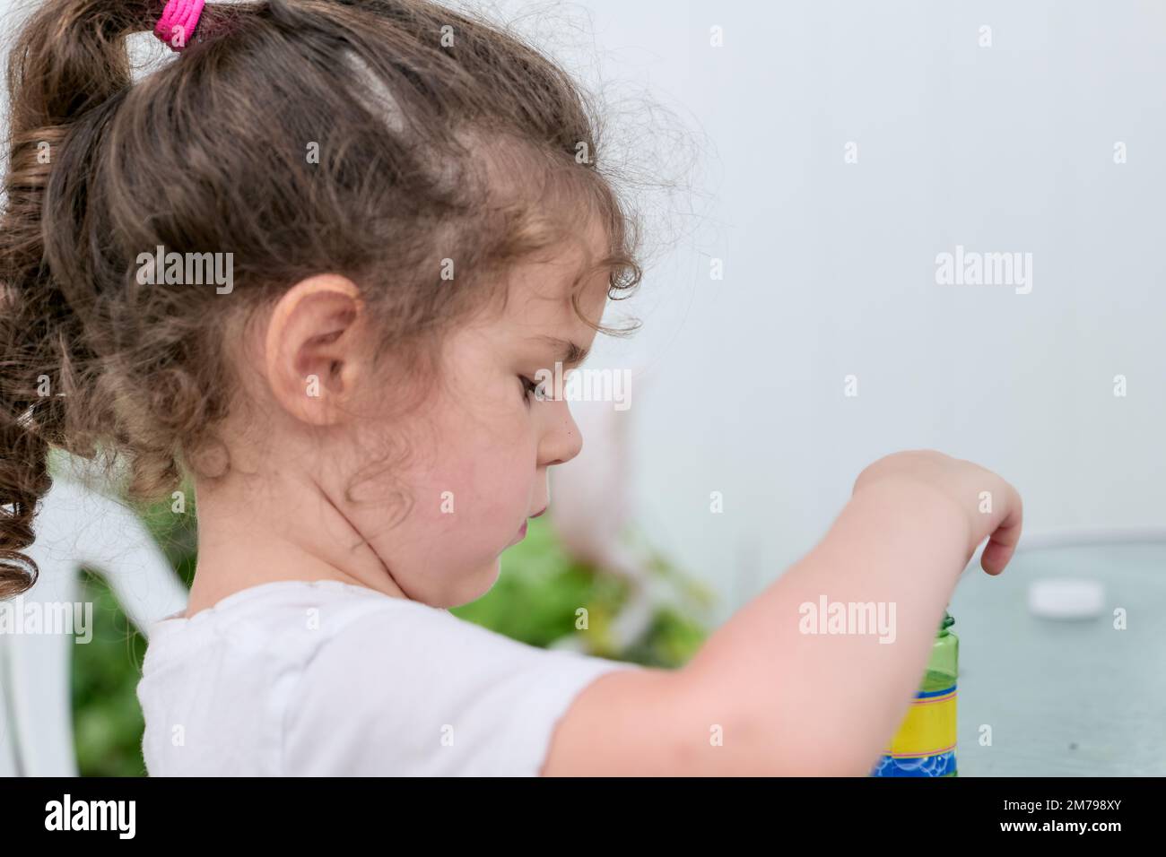 pretty young girl playing with soap bubbles in the backyard Stock Photo ...