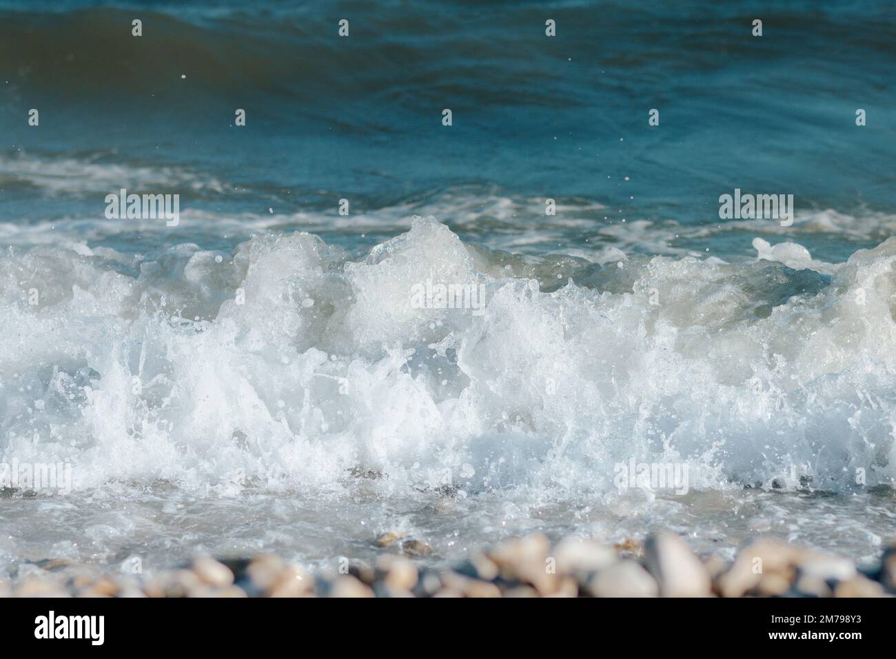 Beach pebbles washed away by the sea waves Stock Photo - Alamy