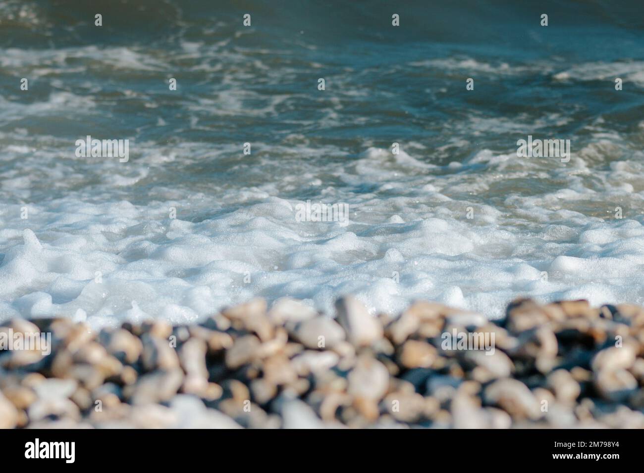Beach pebbles washed away by the sea waves Stock Photo - Alamy