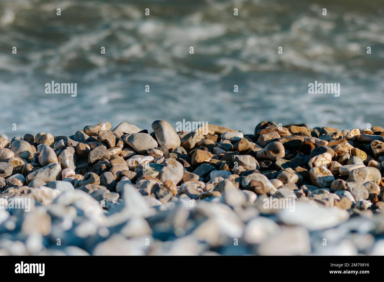 Beach pebbles washed away by the sea waves Stock Photo - Alamy