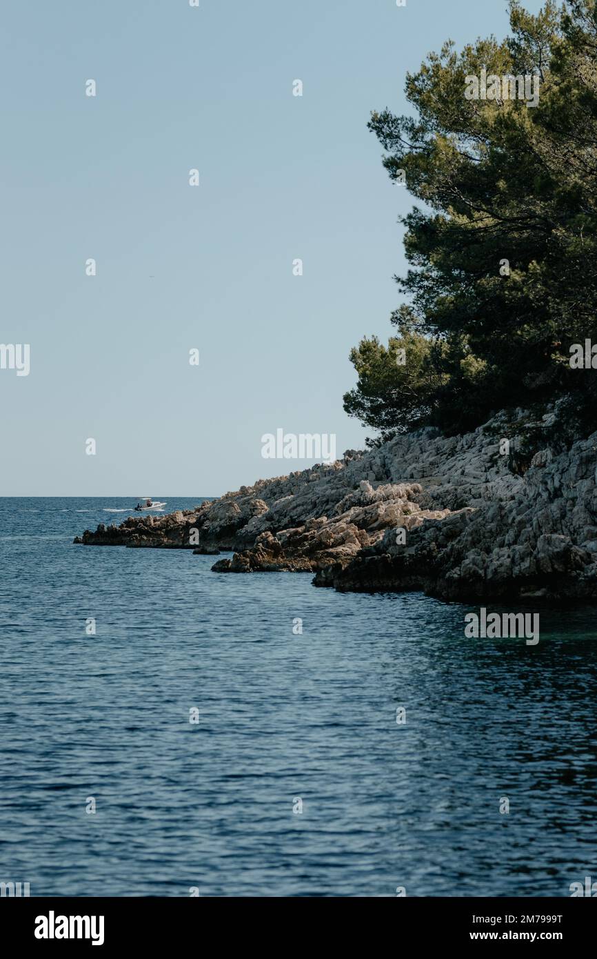 Summer coastline near an island on the deep blue ocean Stock Photo - Alamy