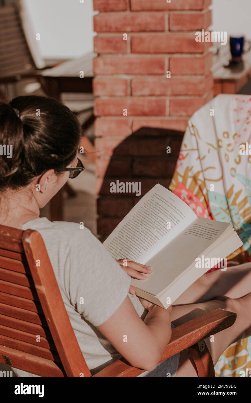 Girl from behind reading a book with an amazing view in front of her of ...