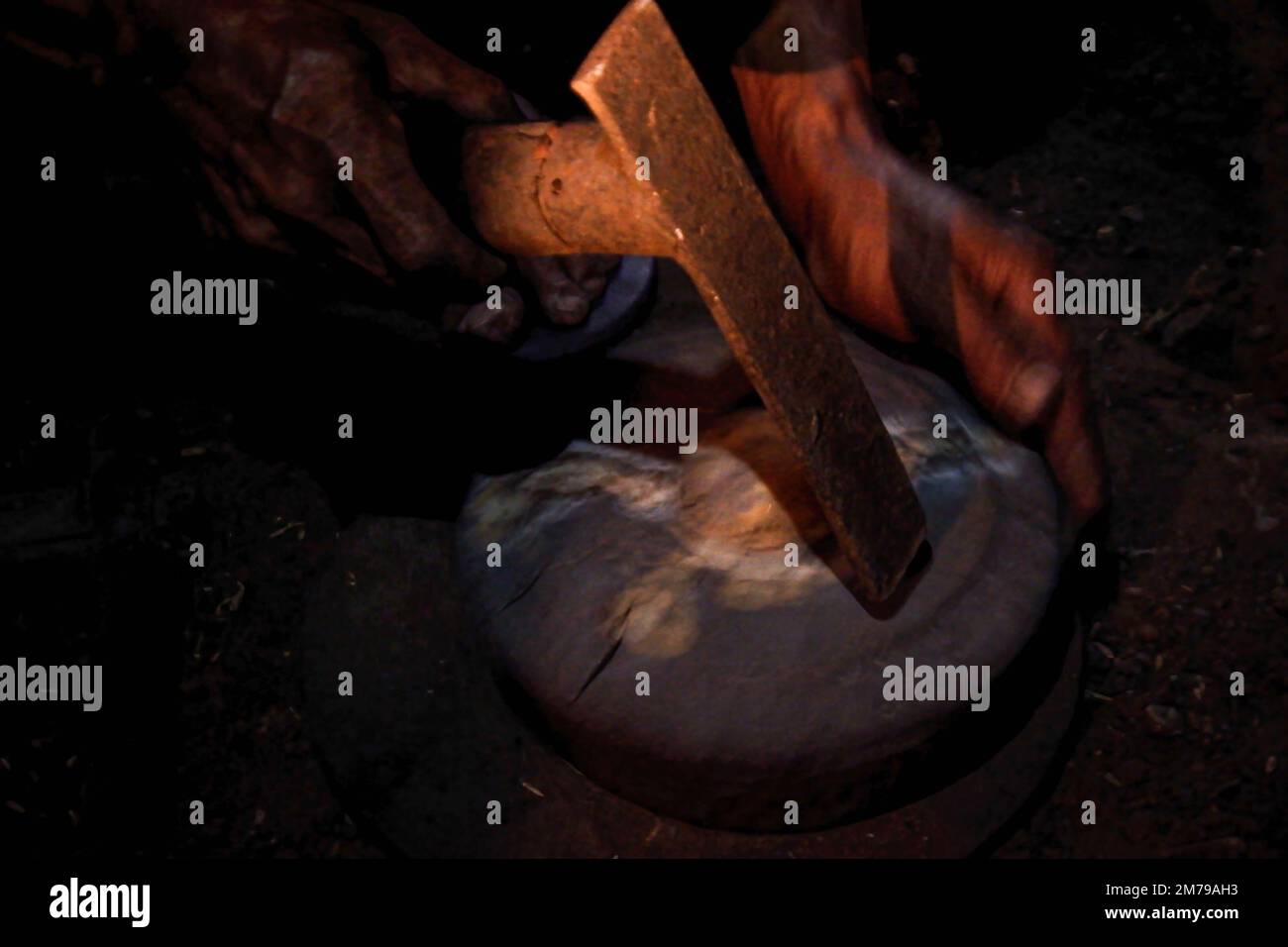 A gong craftsman strikes the gong plate. The process of making a gong ...