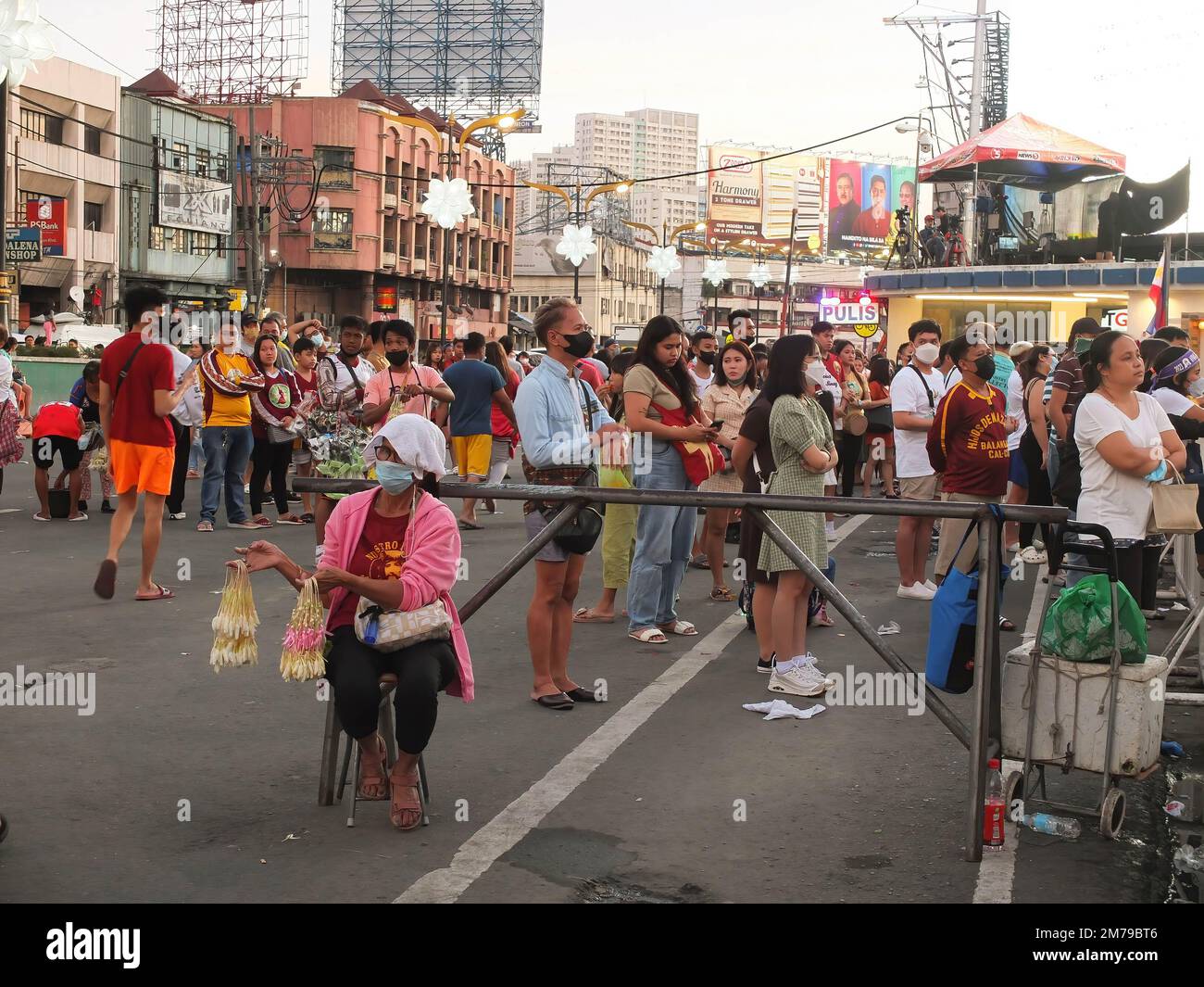 Devotees standing along Quezon Boulevard listening to the mass at ...