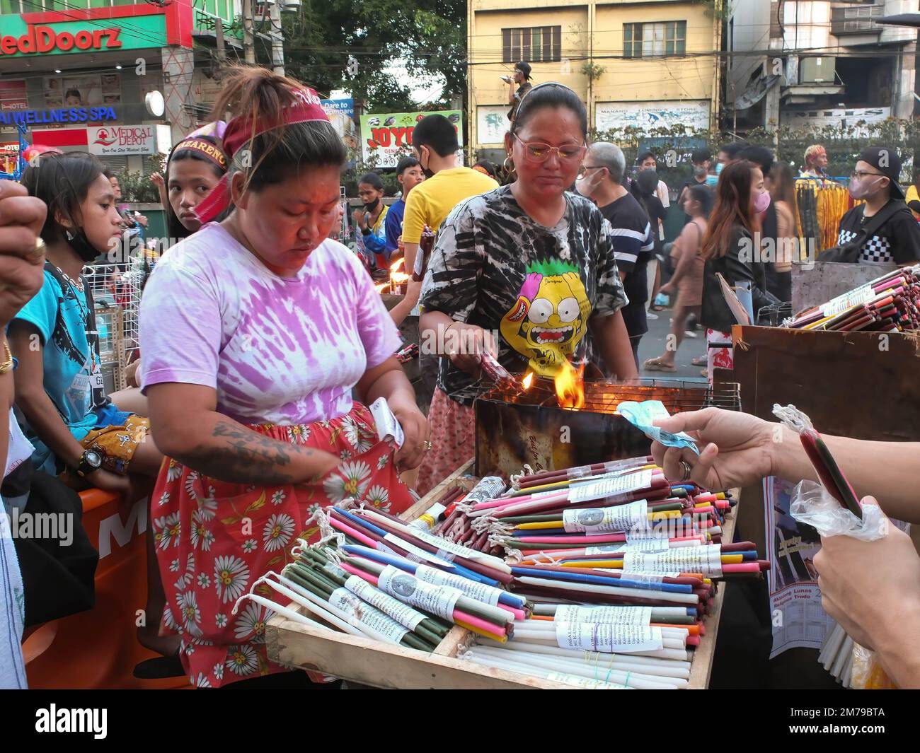 A vendor busy selling candles outside the Quiapo Church. Catholic ...