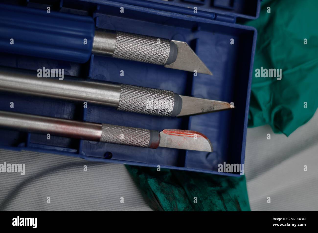 A box with surgical instruments over dirty bloody plastic gloves Stock ...