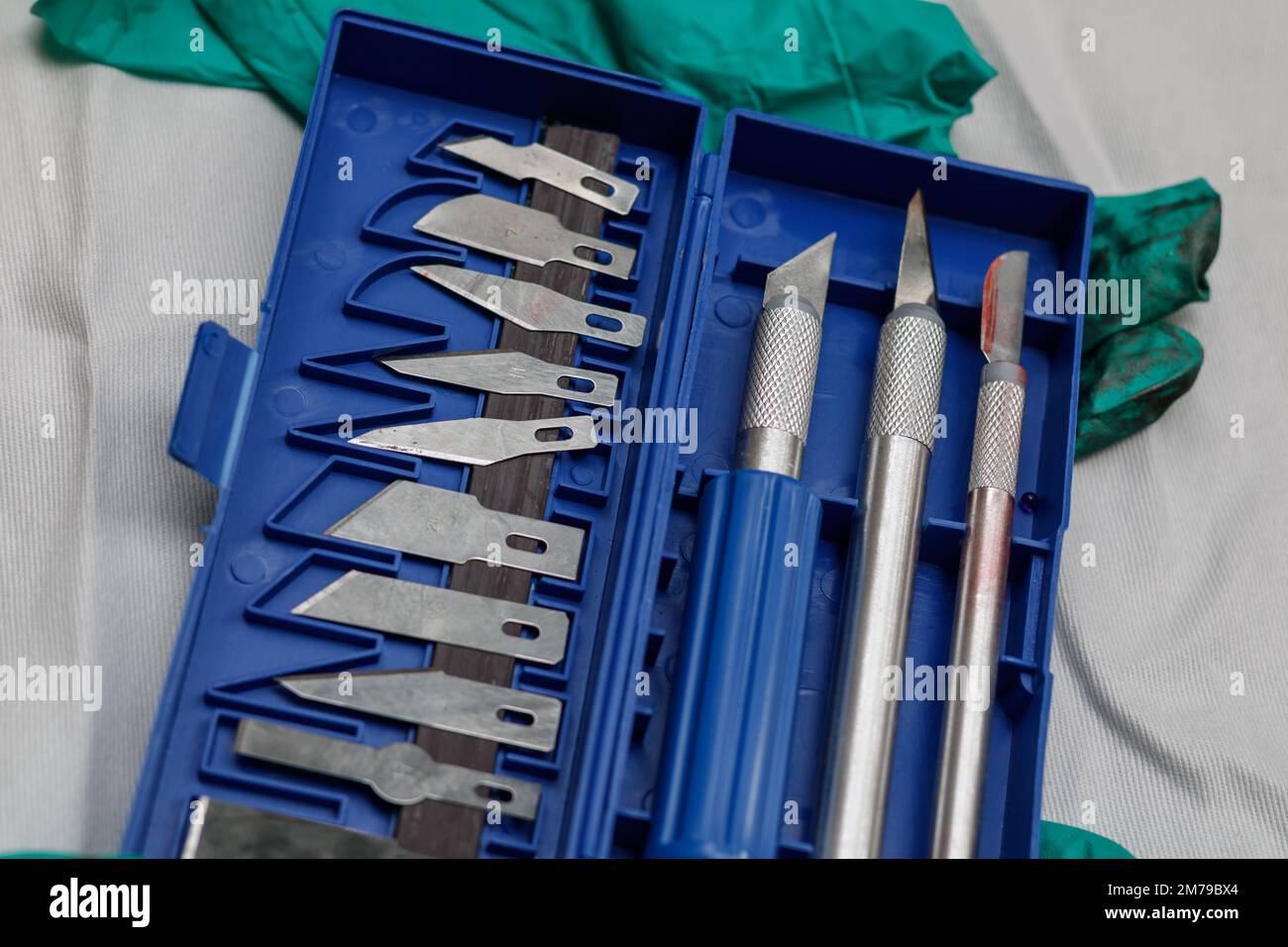 A box with surgical instruments over dirty bloody plastic gloves Stock ...