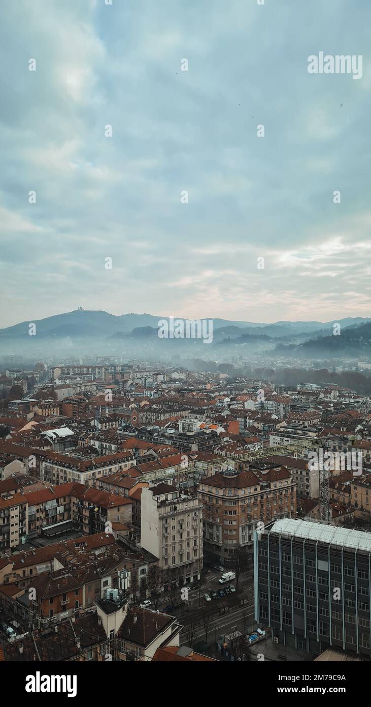 An aerial vertical shot of Turin city view in Italy with cloudy sky and ...