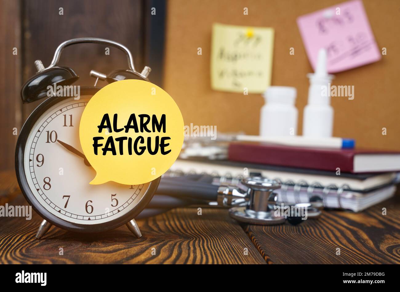 Medical concept. On the alarm clock a sticker with the inscription ...