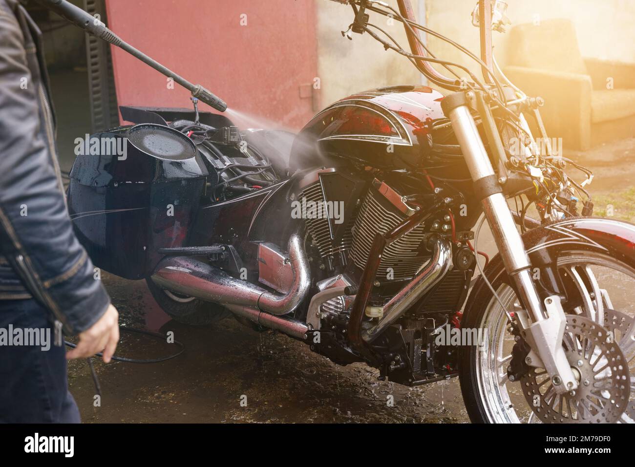 Washing a motorcycle engine with a high pressure jet. Close-up Stock ...