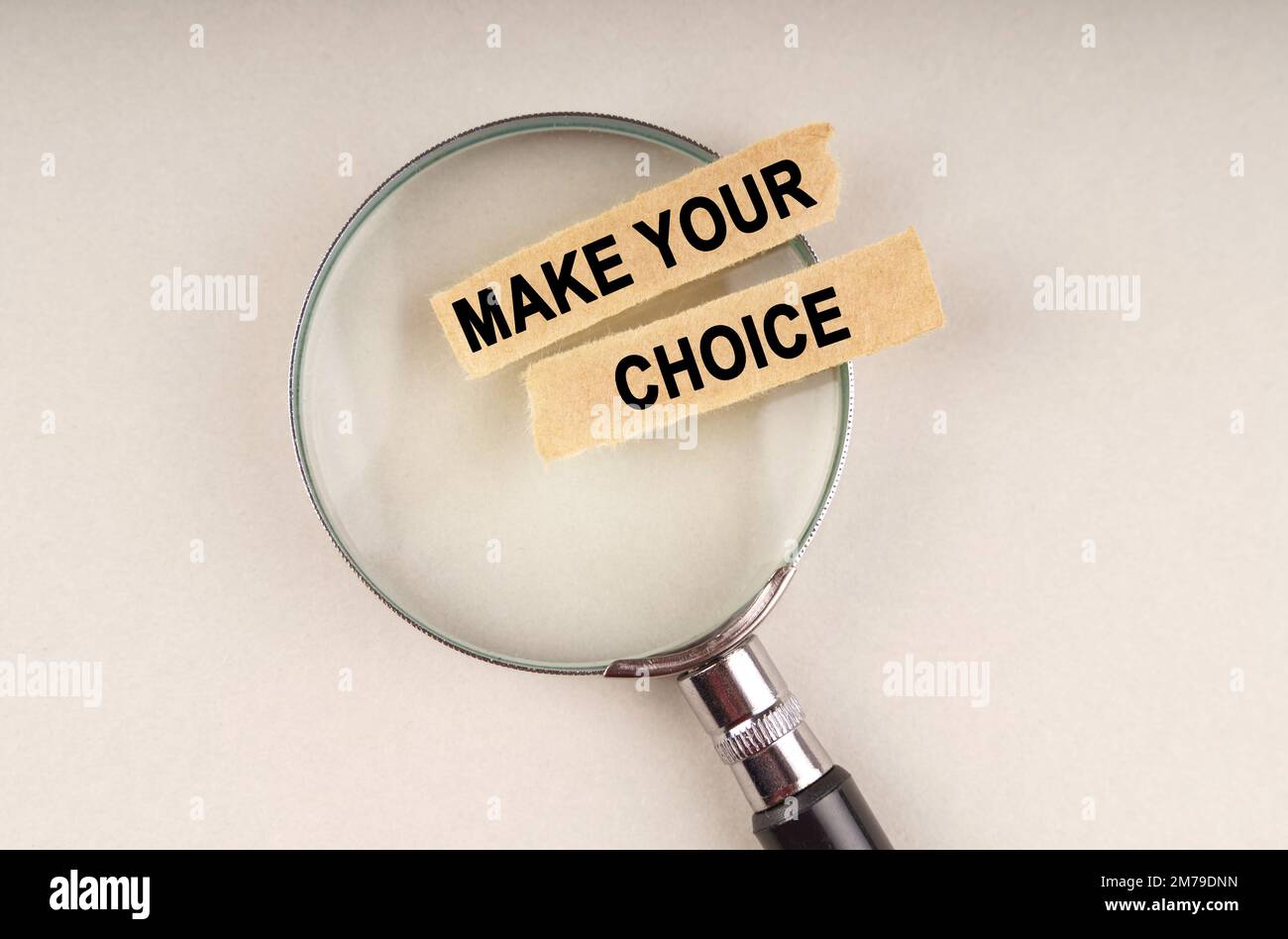 On the magnifying glass are paper strips with the inscription - MAKE ...