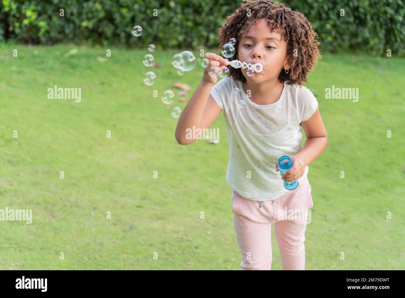 Smiling girl soap bubbles in hi-res stock photography and images - Alamy