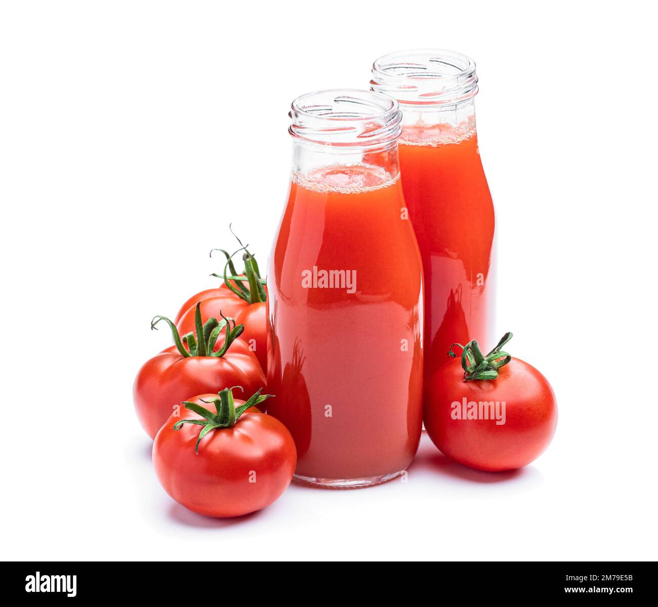 Bottles of tomato juice and ripe tomatoes isolated on white background ...