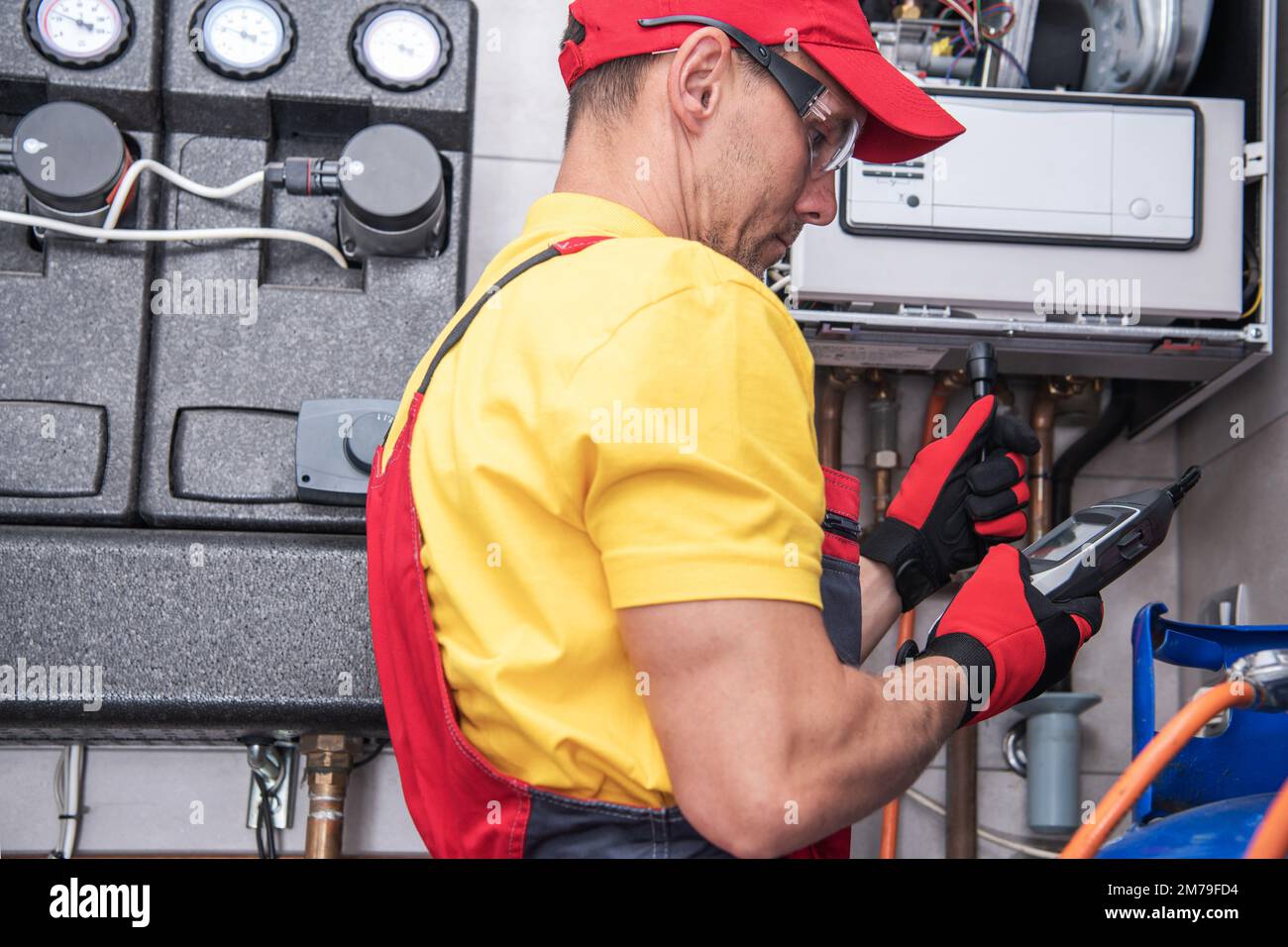 Professional Plumber Performing Residential Water Heating System Check ...