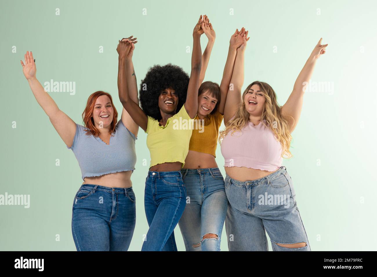 Multiracial group of women holding hands and having fun. Group of young ...