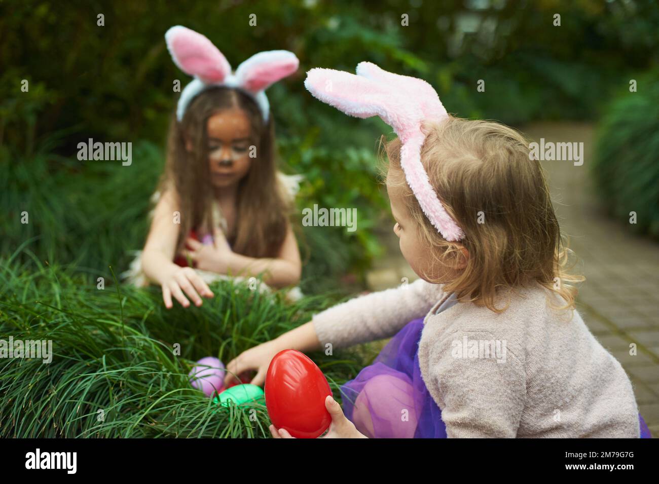 Easter egg hunt. Group Of Children Wearing Bunny Ears Running To Pick ...