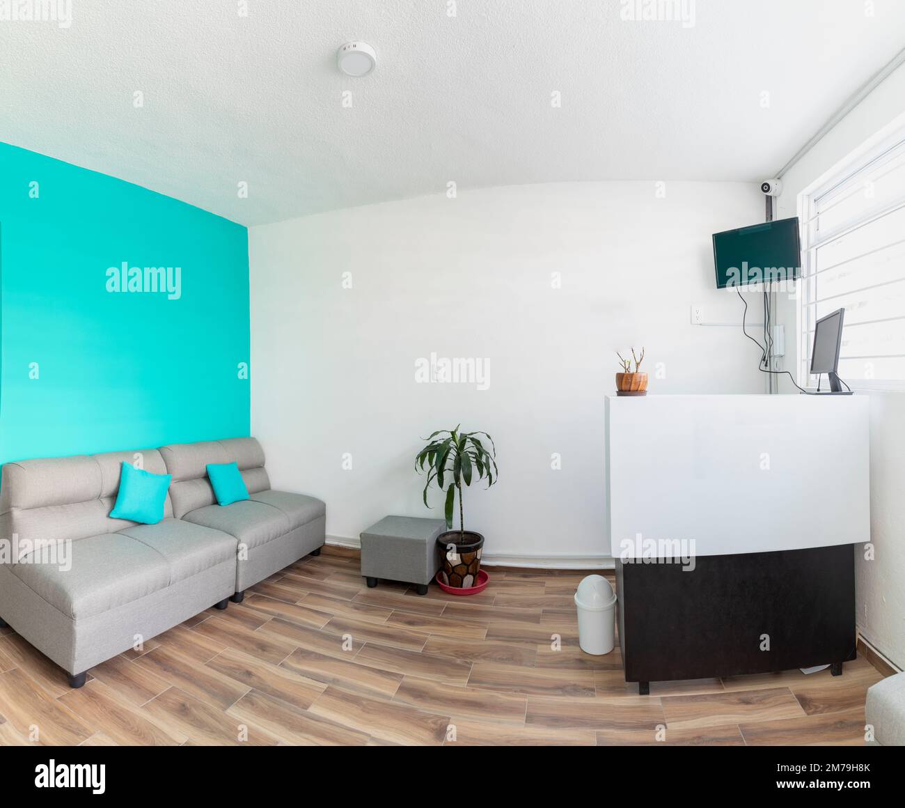 Reception of a rehabilitation clinic, with a desk and chairs to wait ...