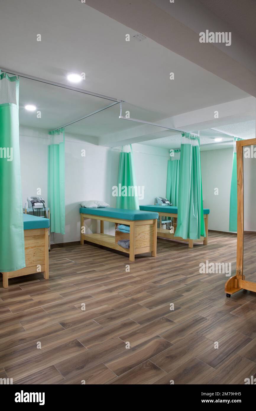 Vertical image of some stretchers with curtains in a rehabilitation ...