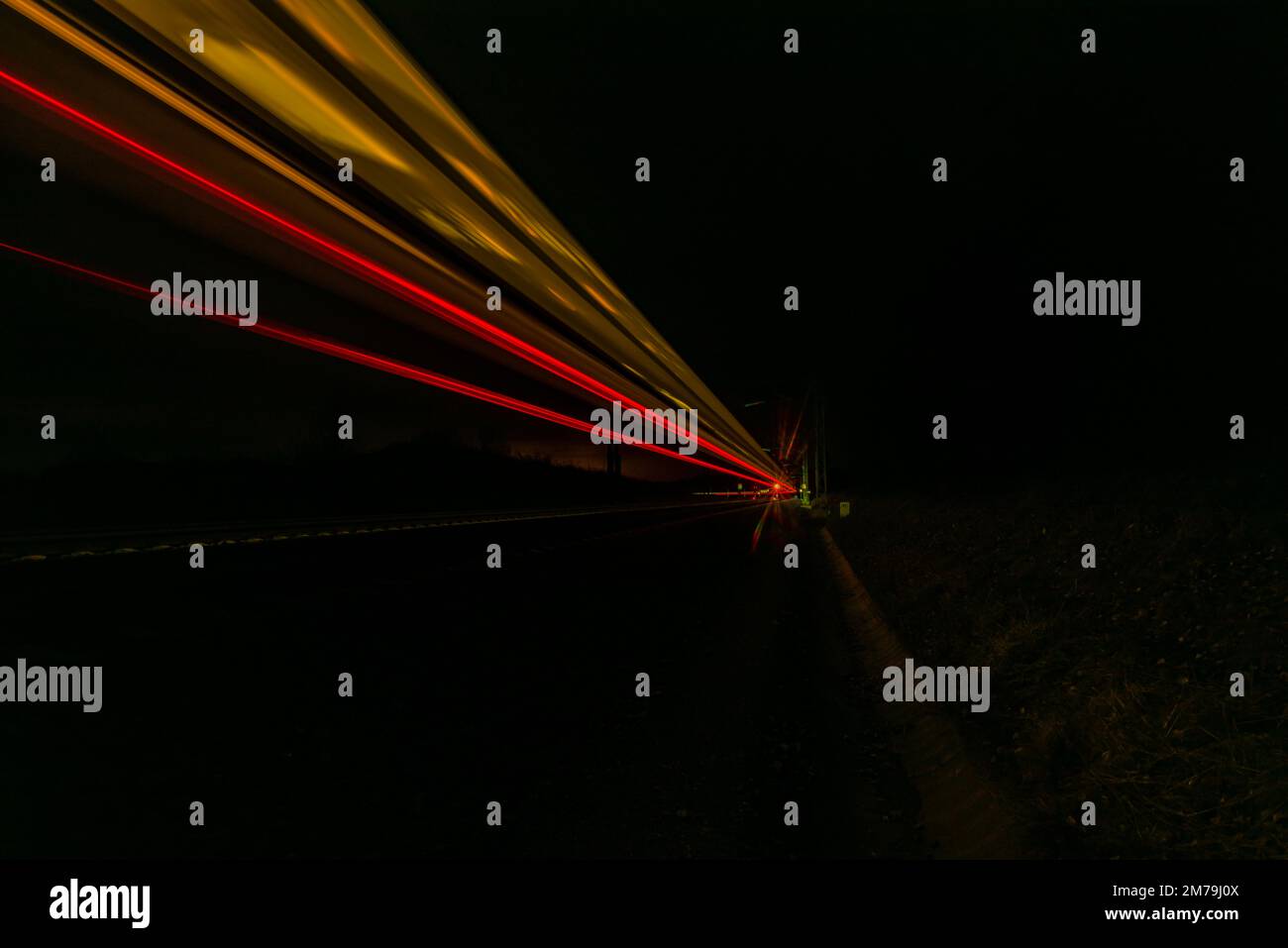 NIght dark color train lines in night between Prague and Tabor towns in ...