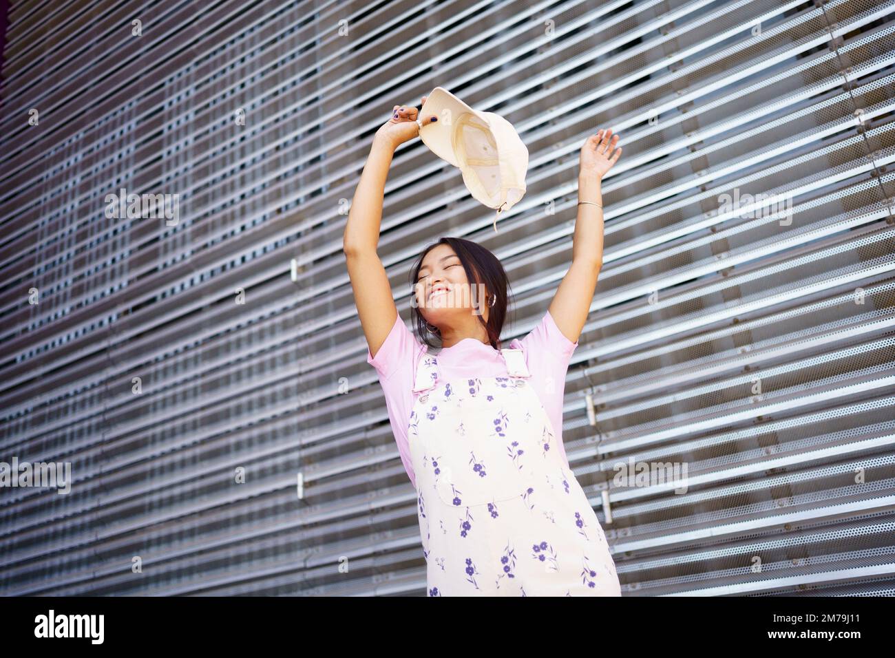 Young Asian woman dancing with raised arms Stock Photo - Alamy