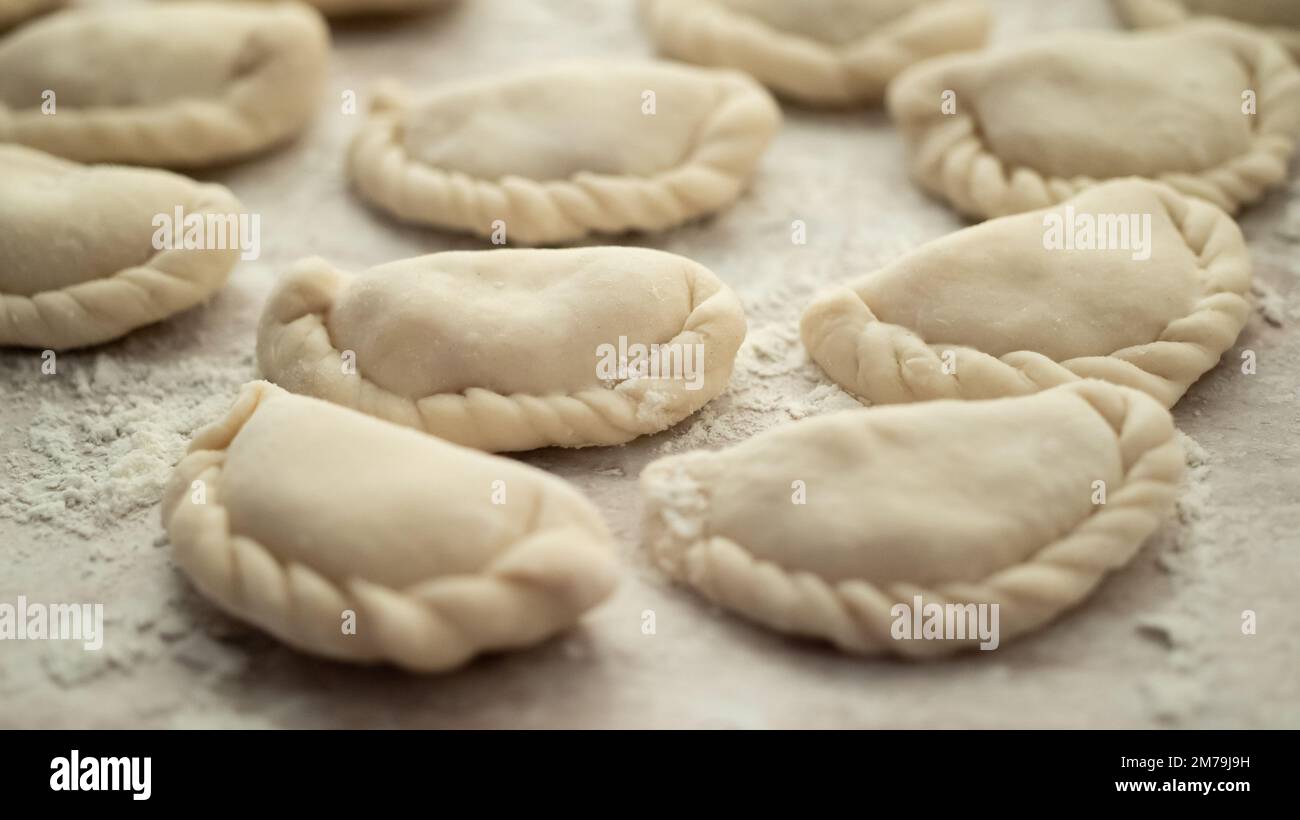 Raw homemade varenyky Ukrainian traditional dish. National food kitchen ...