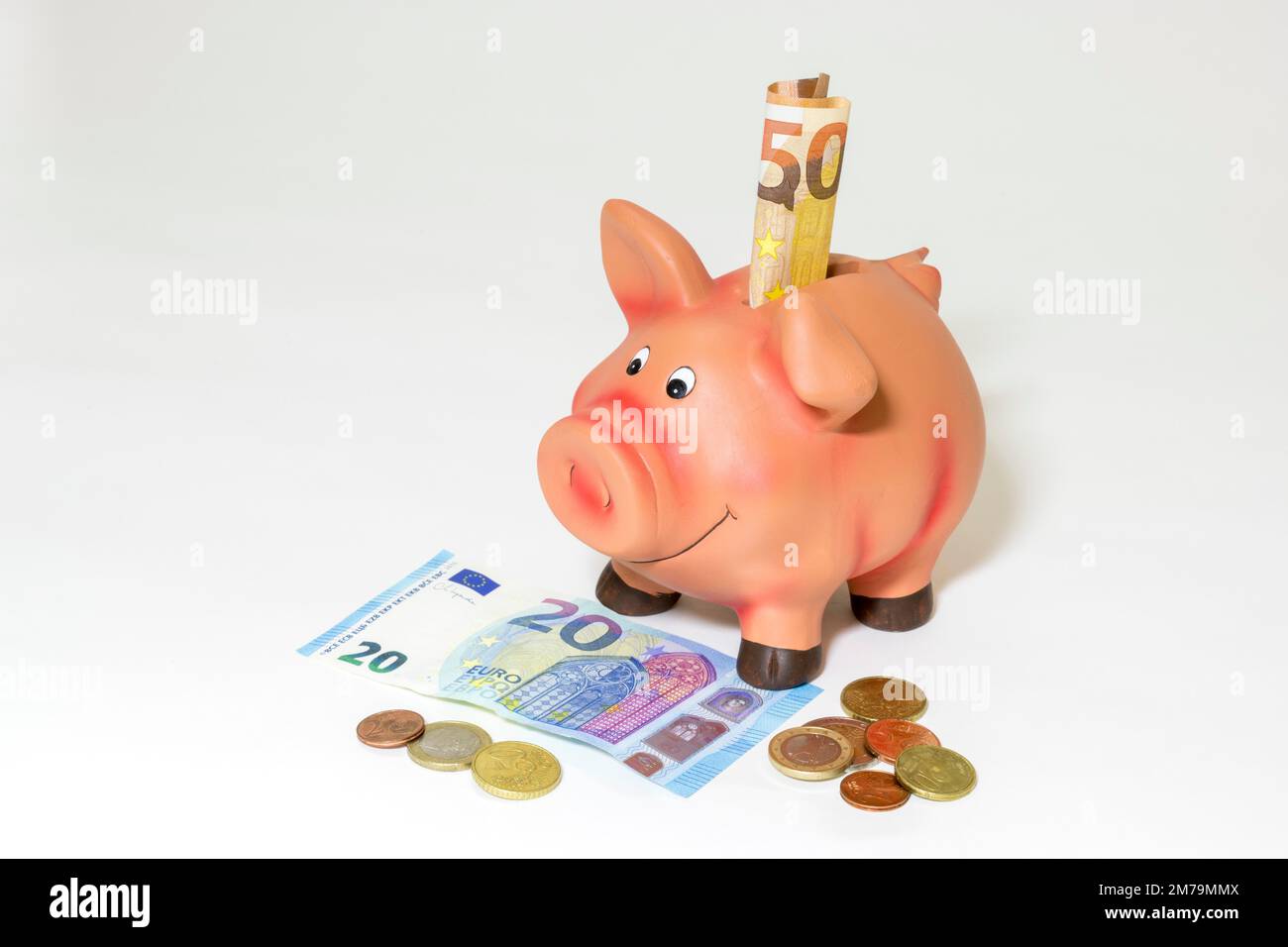 Pink piggy bank with euro notes and coins, 50 euro, 20 euro, cent ...