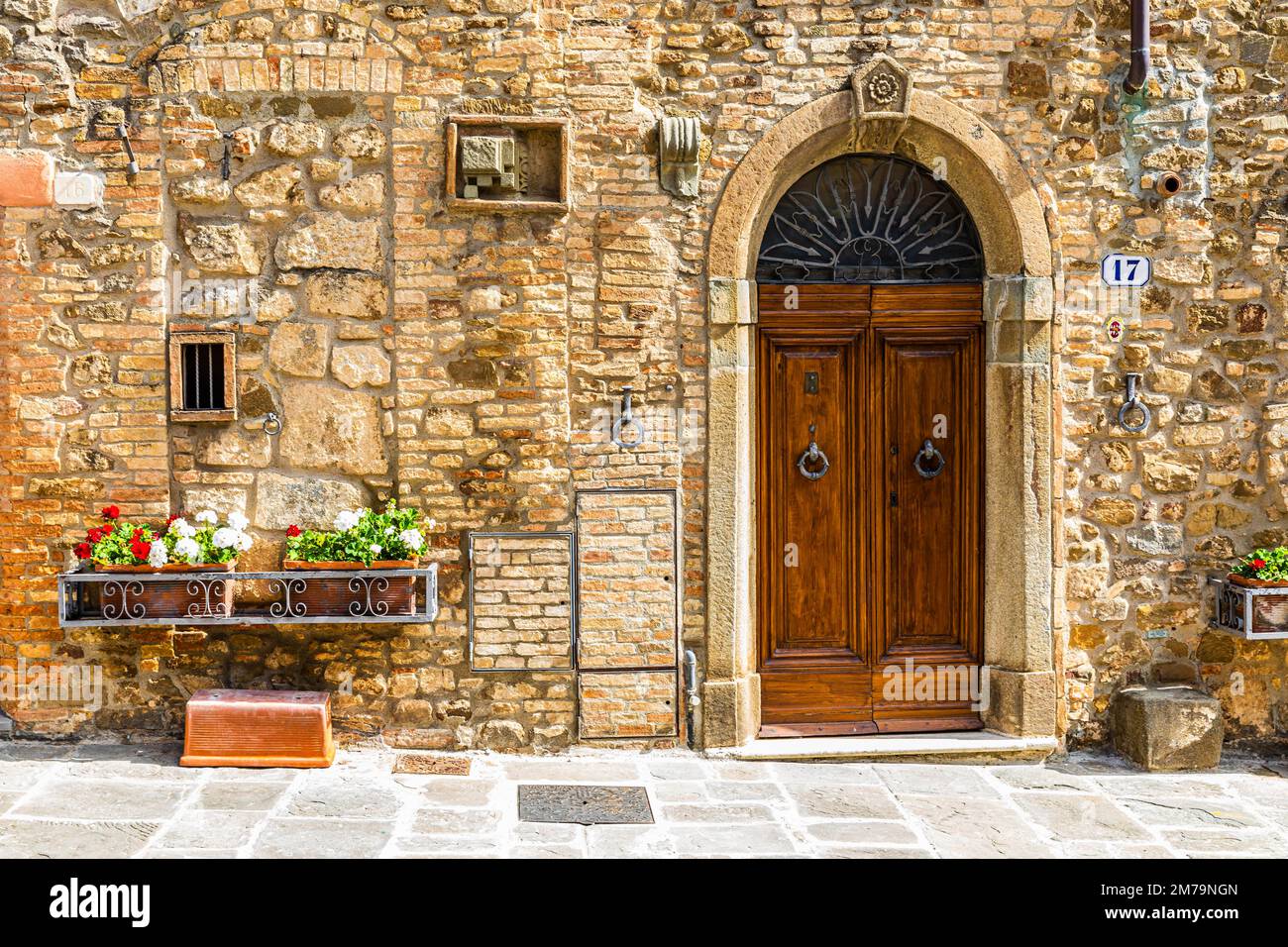 House entrance with round arch front door decorated with flower boxes ...