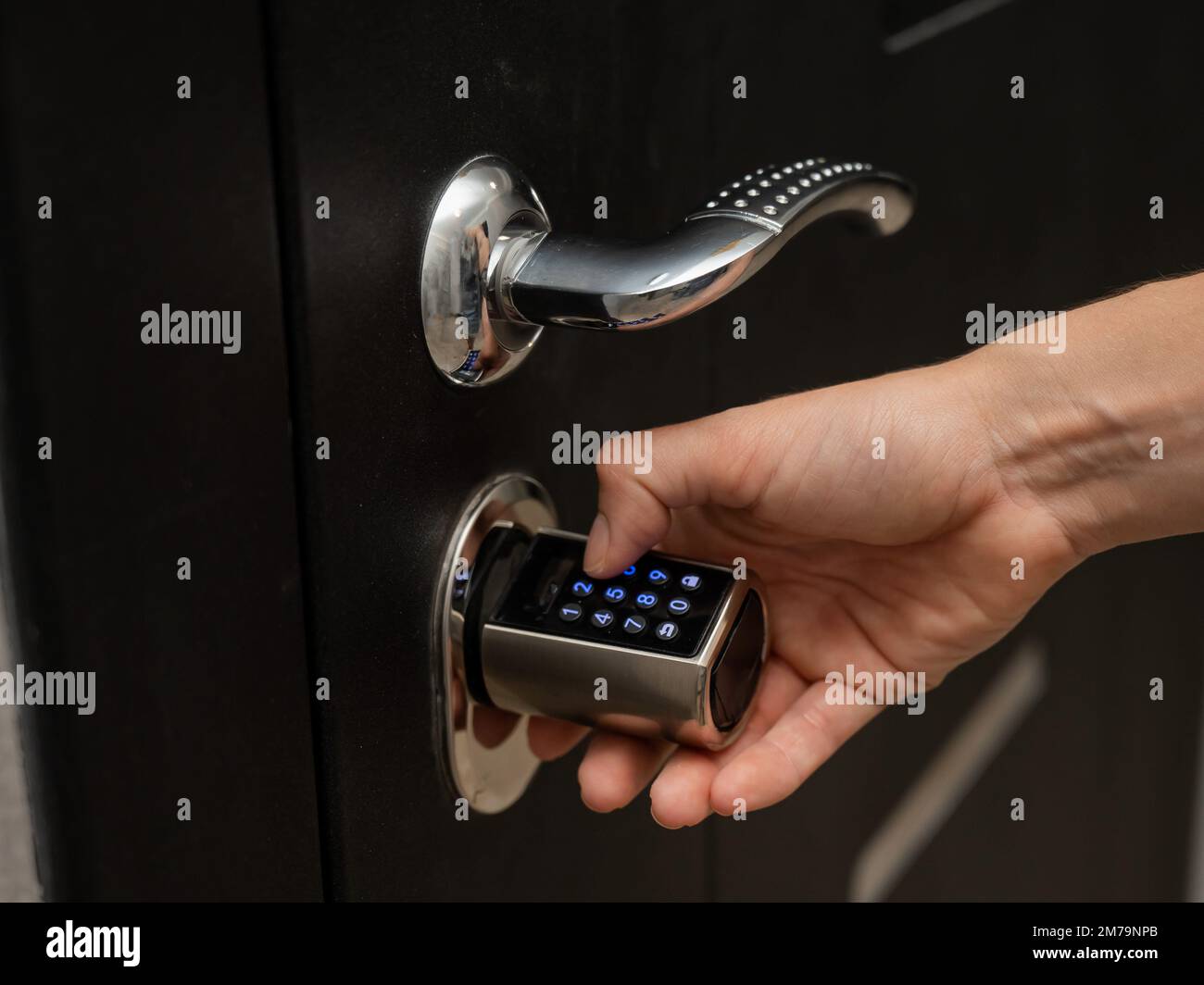 Woman opens the combination lock on the door to the apartment. Keyless ...