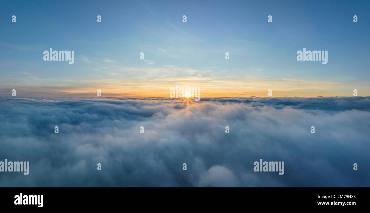 Aerial view of a sunrise, above a layer of fog, during an inversion ...