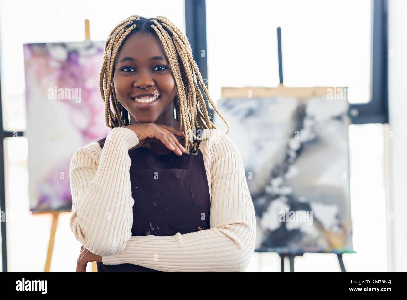 african american woman student in art class inspired and painting Stock ...