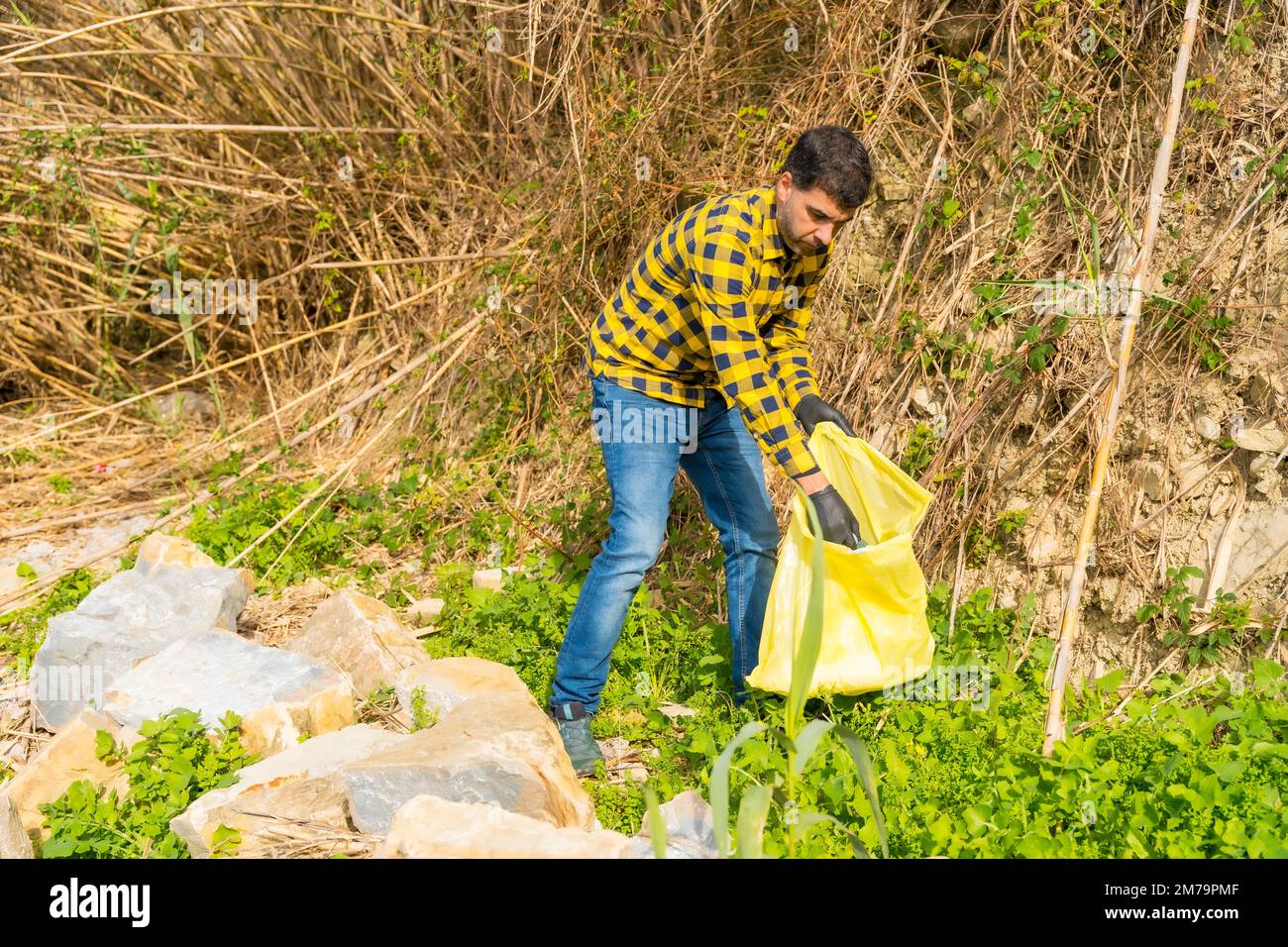 Portrait of man collecting garbage in a forest. Ecology, clean nature from plastics Stock Photo ...