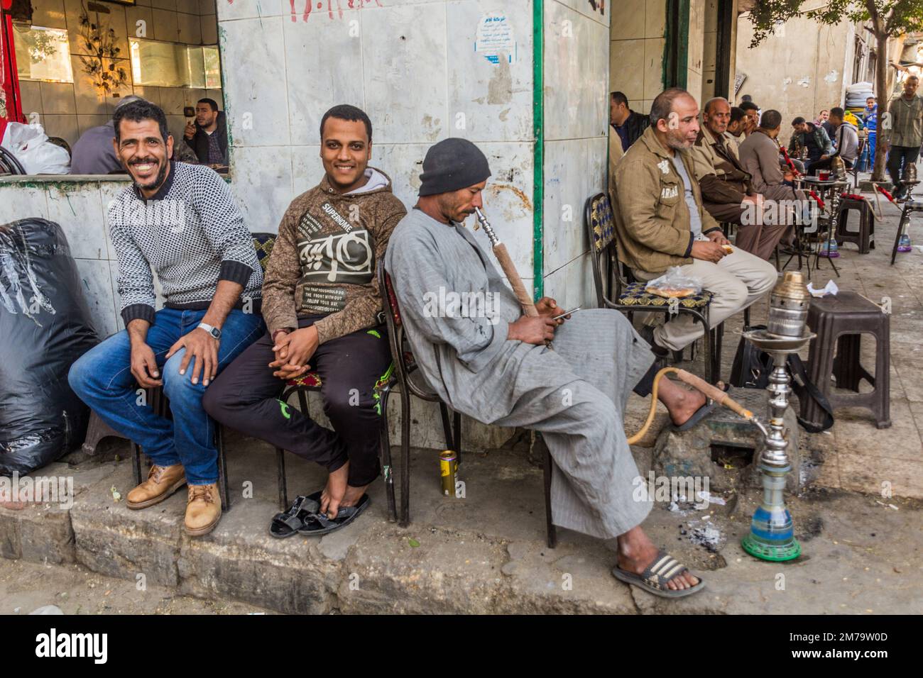 CAIRO, EGYPT - JANUARY 26, 2019: Local men in a traditional street cafe ...