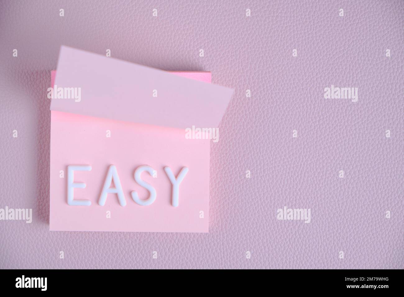 Word easy laid out white letters pink piece paper.Concept simplicity ...