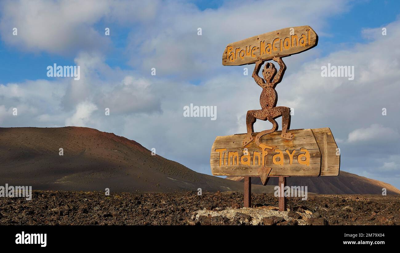 Wooden sculpture and sign at the entrance of the national park ...