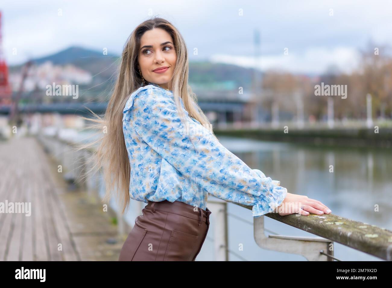 Portrait of young woman walking along the river in the city, lifestyle ...