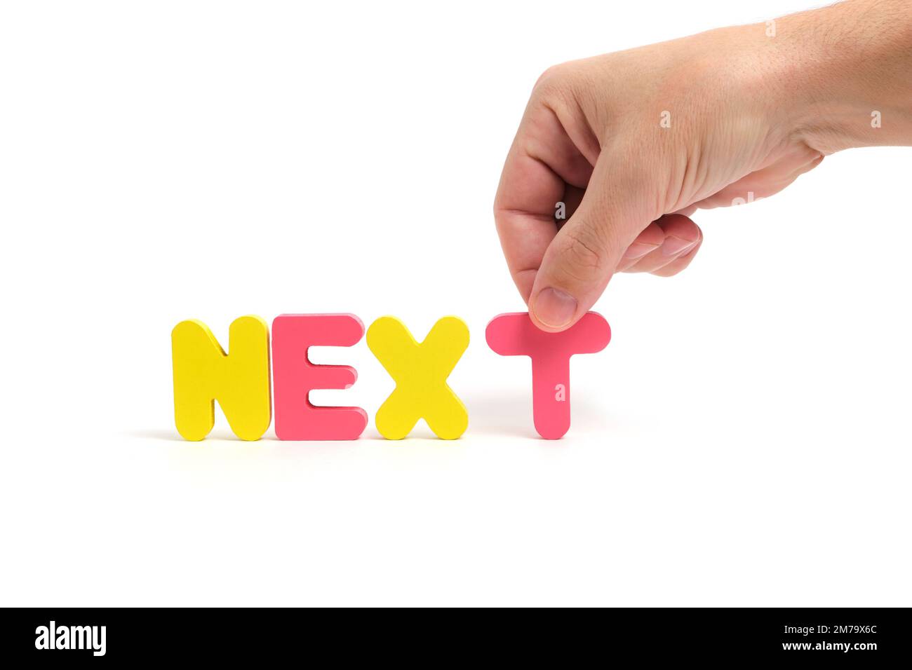 Man hand composes the word next in letters on white background Stock ...