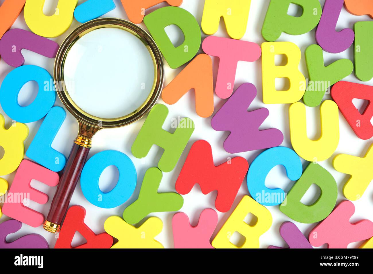 Magnifying glass and bright multicolored letters English alphabet Stock ...