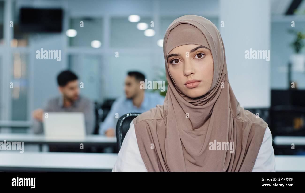 Portrait of pleasant serious arabian businesswoman in hijab confident female insurance broker ...