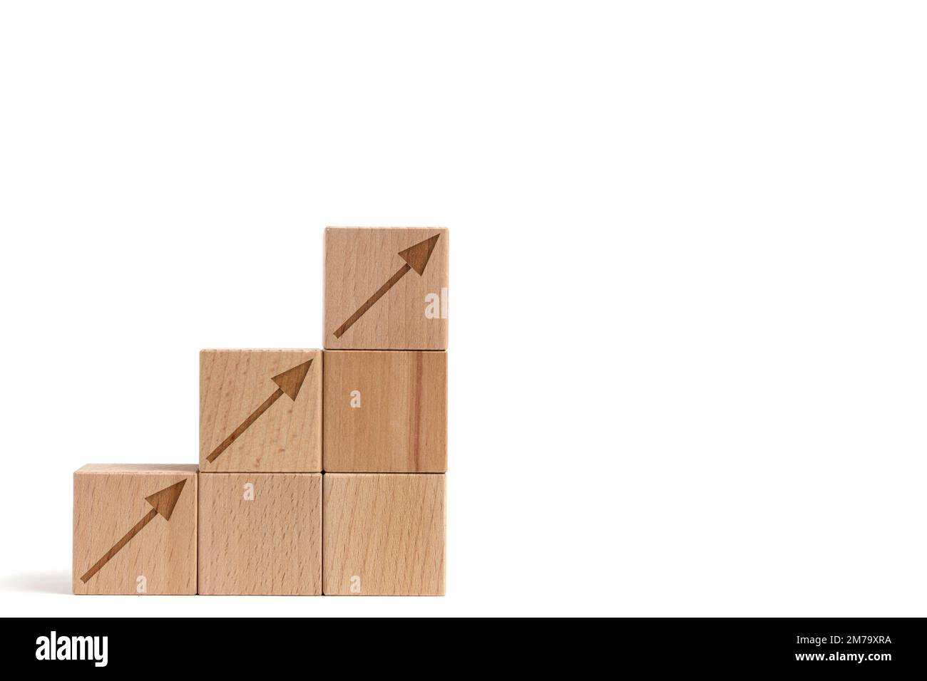Wooden cubes are built form stair and arrows rising top.Concept growth ...