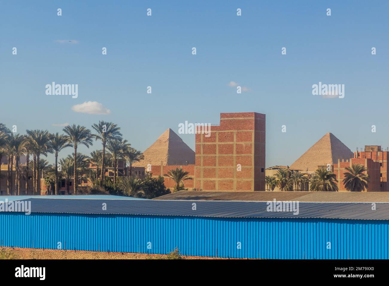 Pyramids behind buildings of Giza, Egypt Stock Photo - Alamy