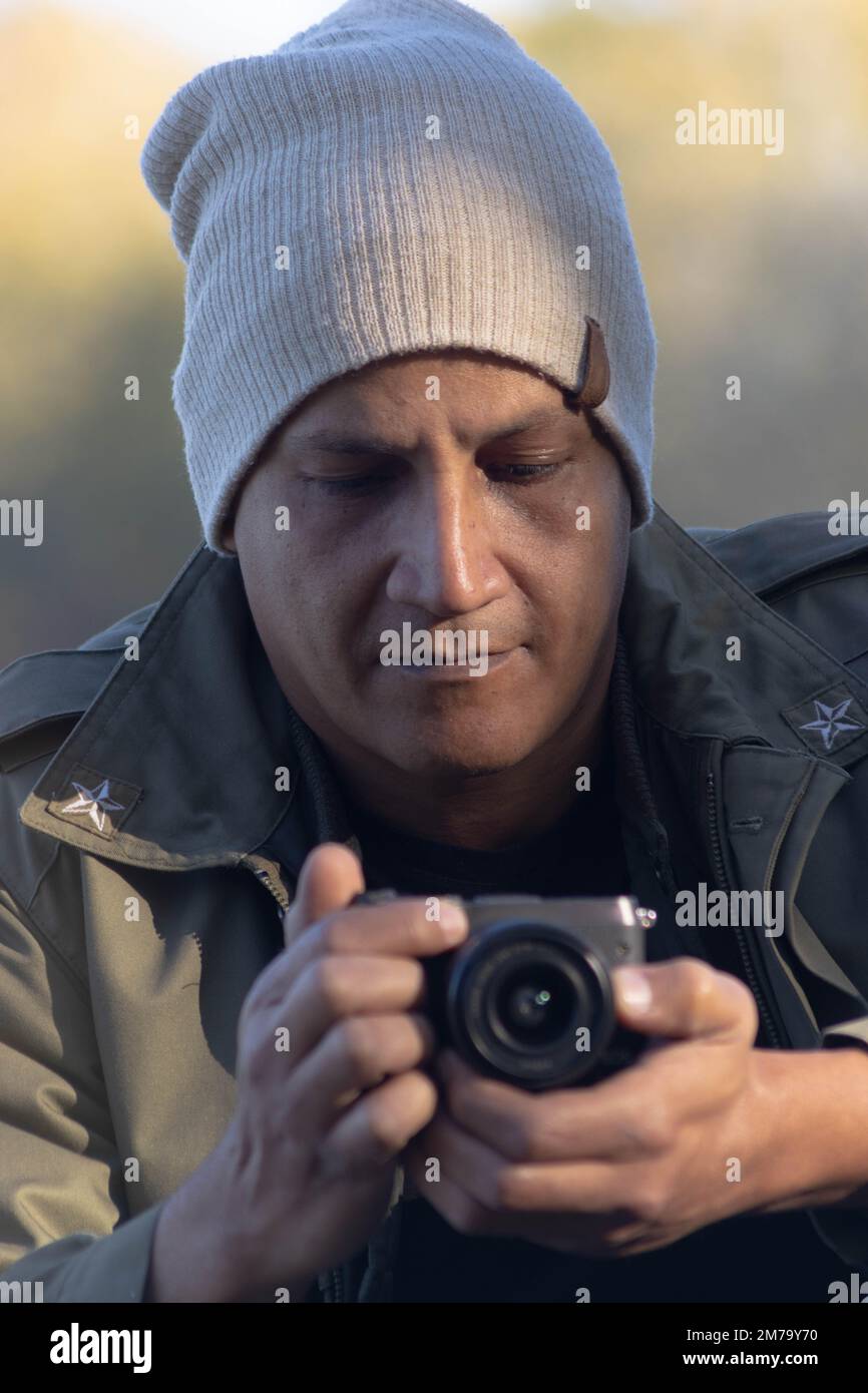 Portrait of traveler man at lake in autumn taking a photo with the ...