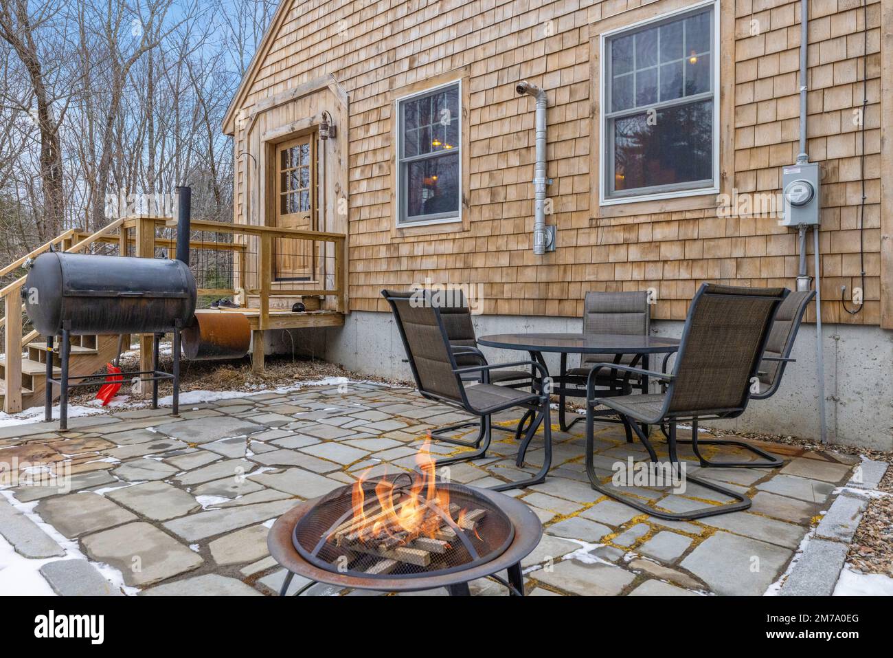 An outdoor view of a rustic wooden design house with cooking set up ...